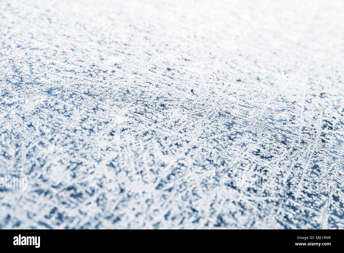 White frost pattern on dark ice, background photo with selective focus ...