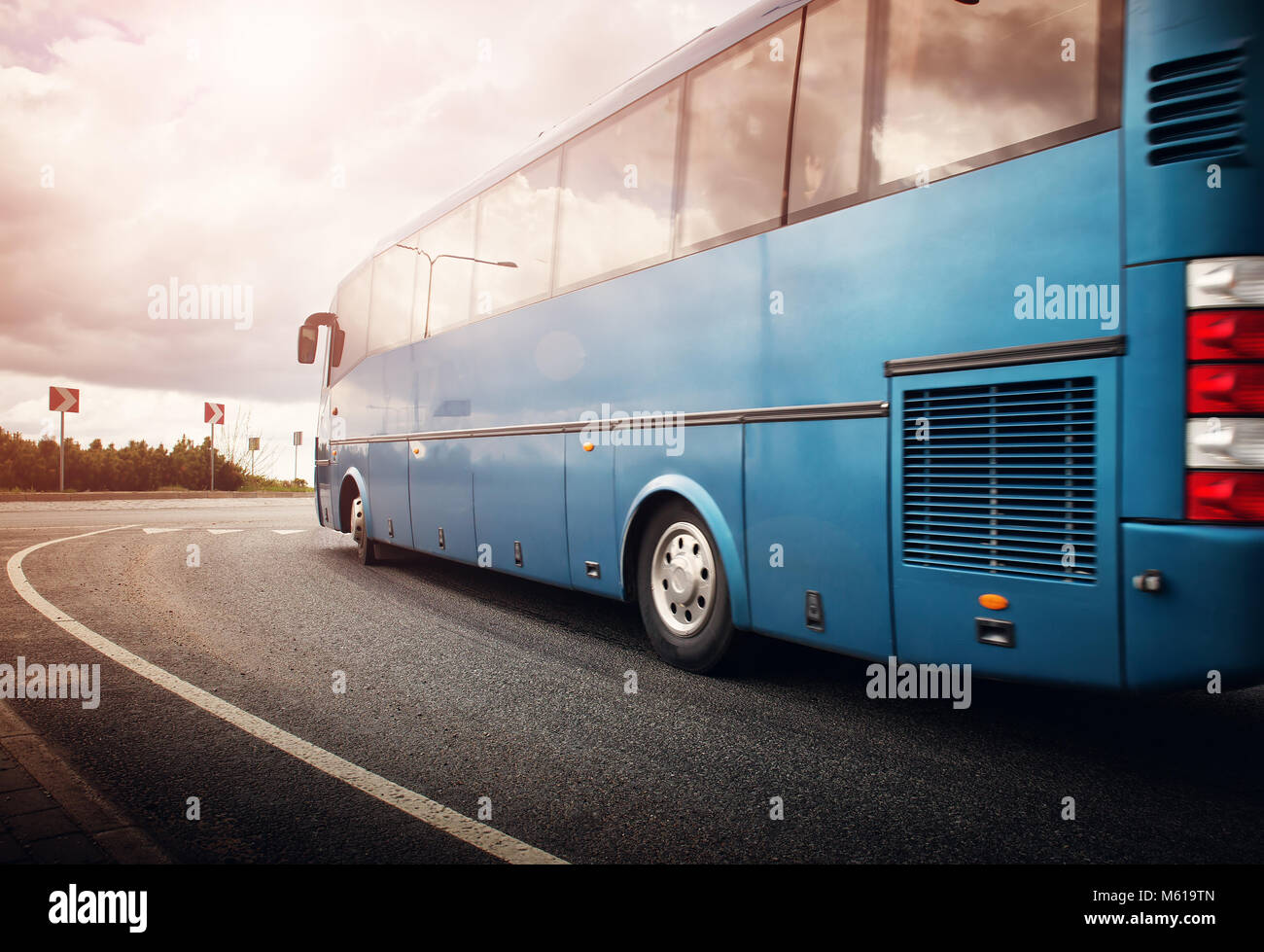 Bus moving on the road in city in early morning Stock Photo - Alamy