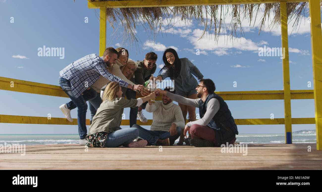Happy Group Of Friends Hanging Out At Beach House having fun and ...