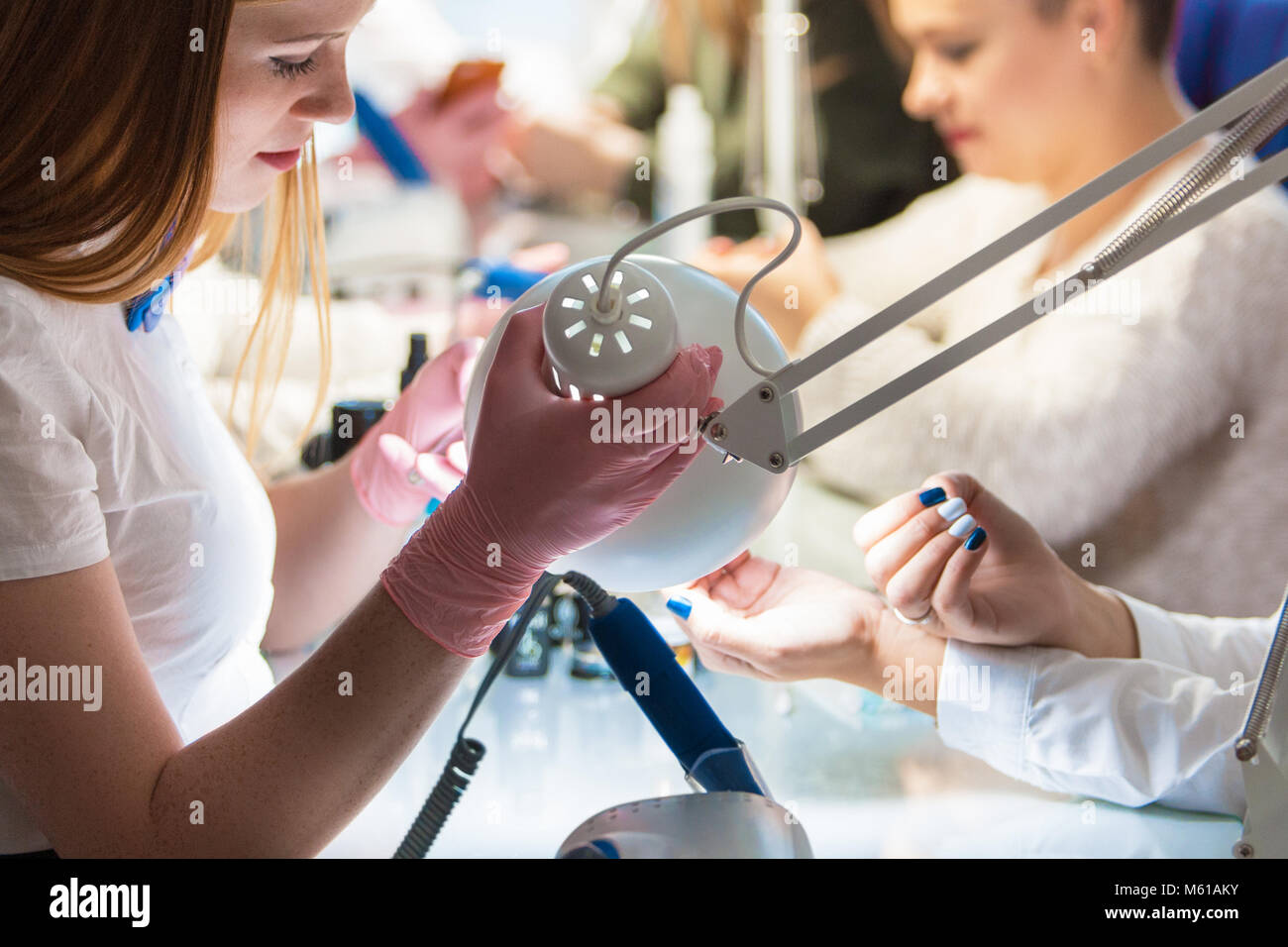 Masters of manicure at work in the beauty salon. Hand care Stock Photo ...