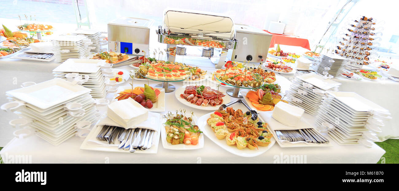 catering table set service with silverware and glass Stock Photo - Alamy