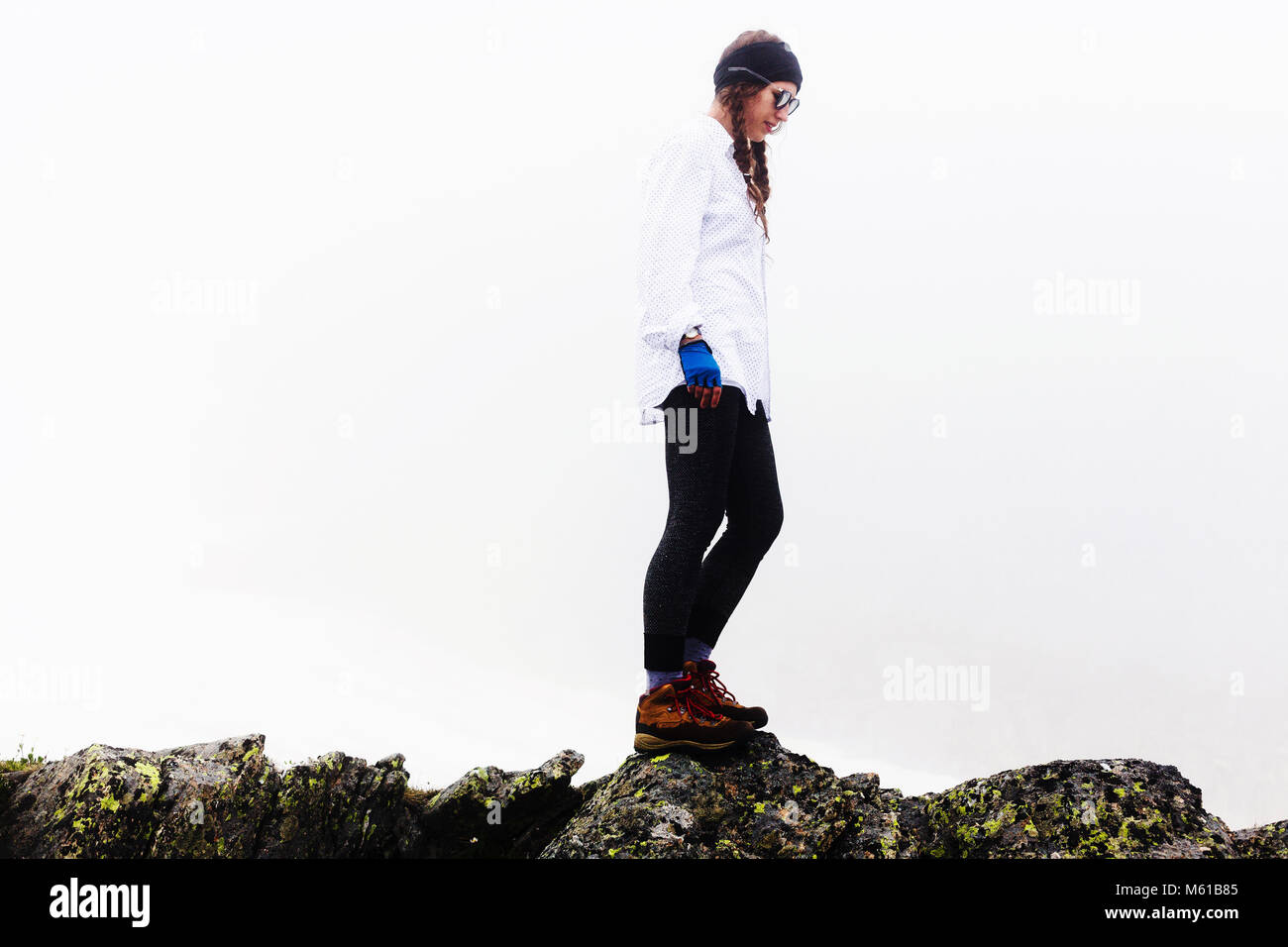 Young traveler woman a walk against the background of an epic rock ...