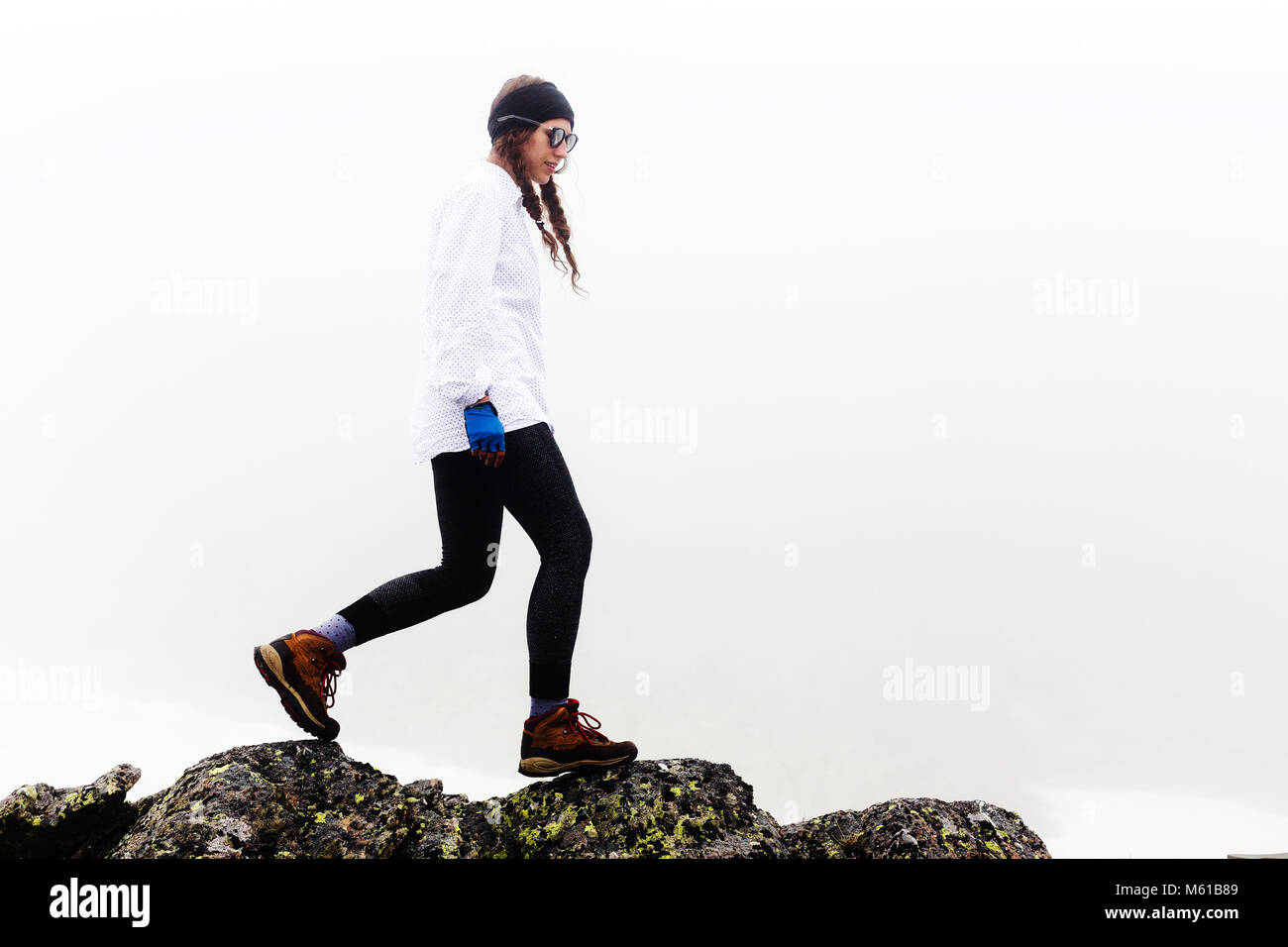 Young traveler woman a walk against the background of an epic rock ...