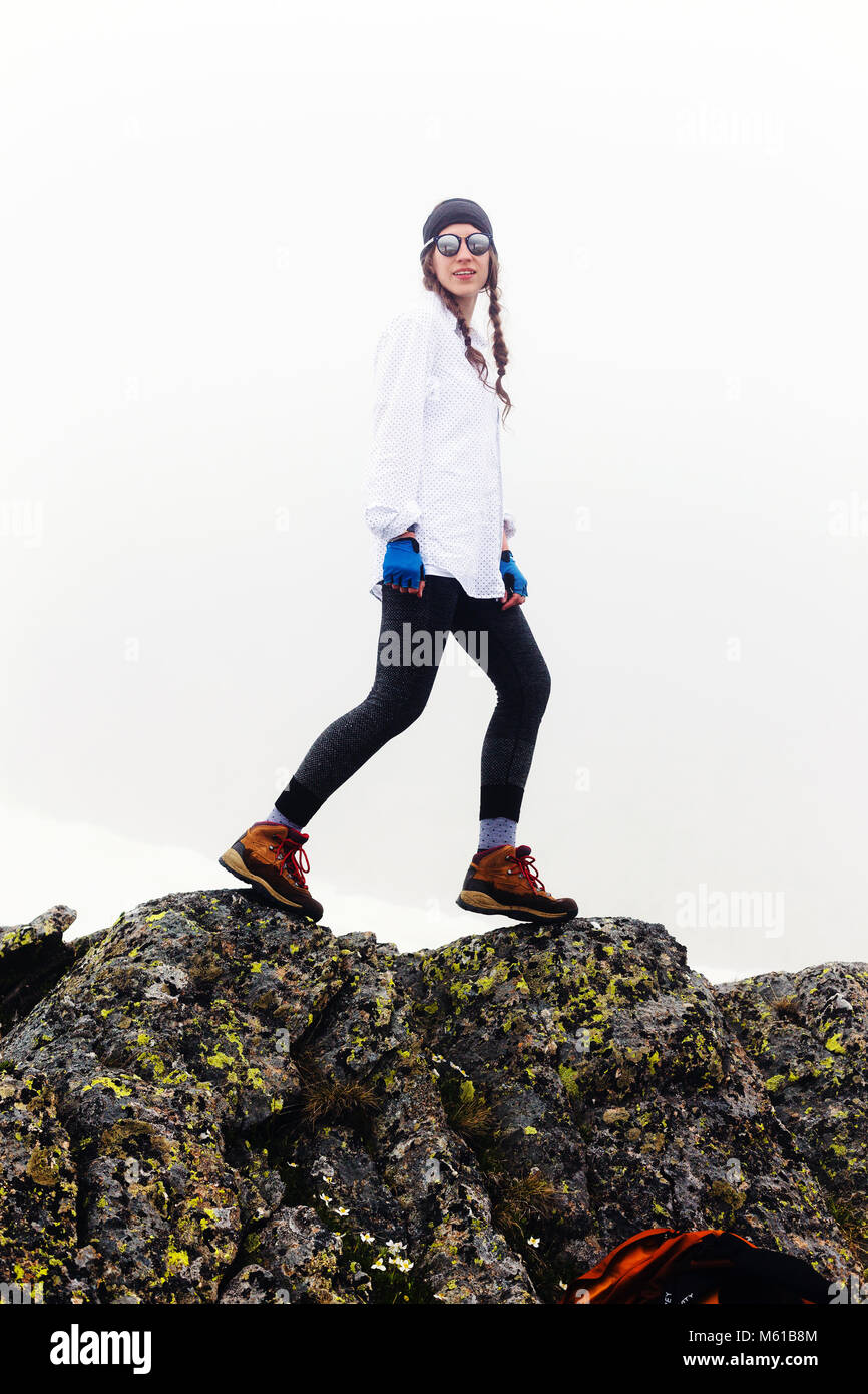 Young traveler woman a walk against the background of an epic rock ...