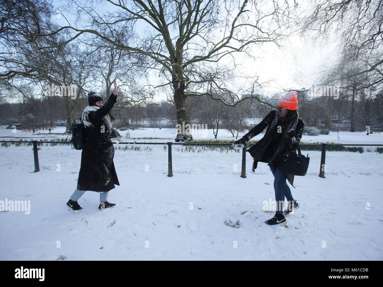 Two women have a snowball fight in St James's Park, London, as heavy ...