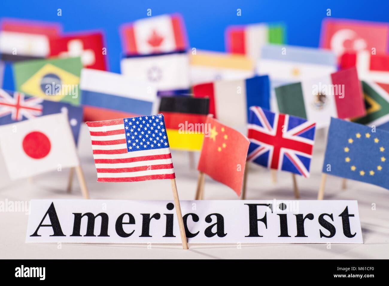 American flag is in front of the slogan America First and many flags of ...