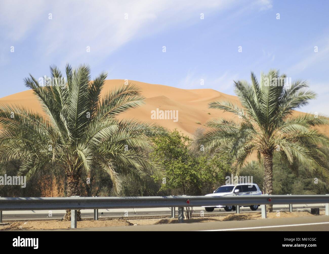A highway through an impressive desert landscape connects the oasis ...