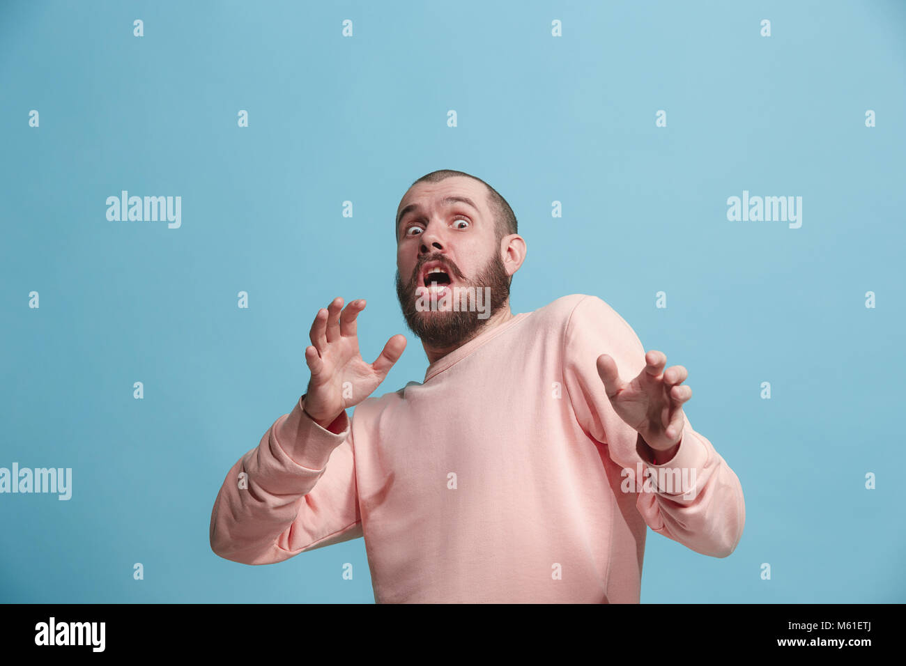 Portrait of the scared man on blue Stock Photo - Alamy