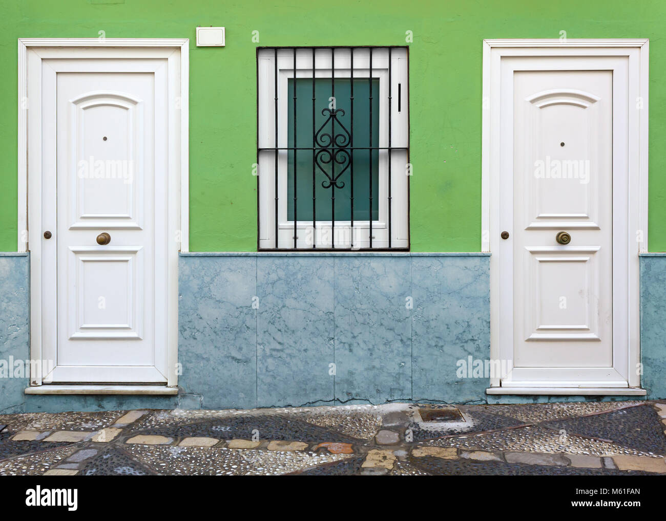 House facade with two white doors and a window in the middle Stock ...