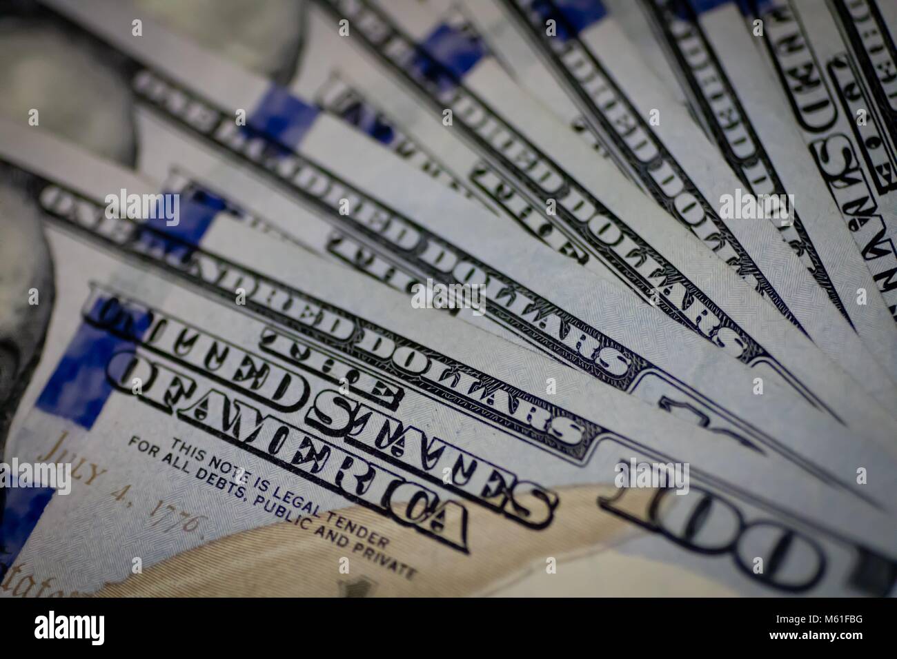 A bunch of 100 Dollar notes, overlapping and stacked on top of each ...