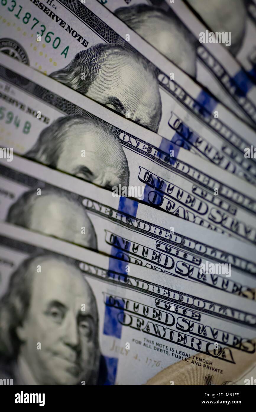 A bunch of 100 Dollar notes, overlapping and stacked on top of each ...