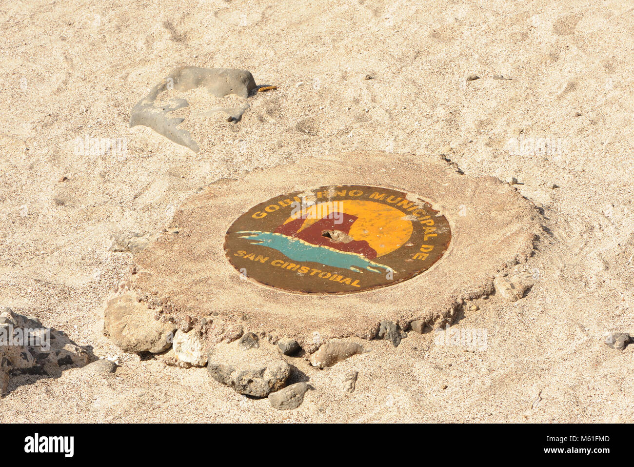 A drain manhole cover on the beach at Puerto Baquerizo Moreno with a ...
