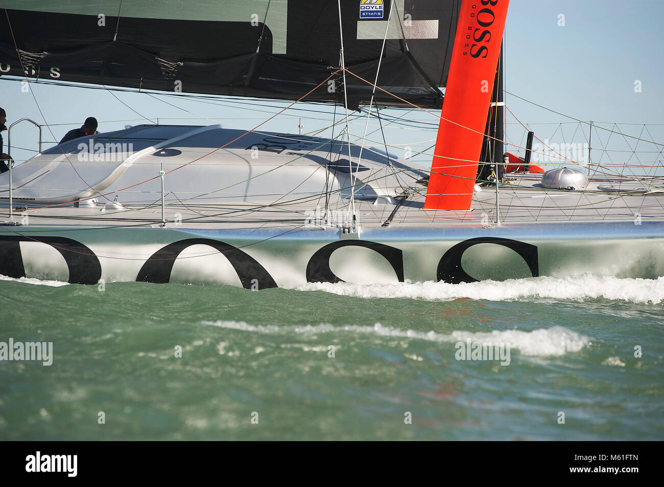 The Open 60 class Hugo Boss 4 motoring across the Solent in 2013. The ...