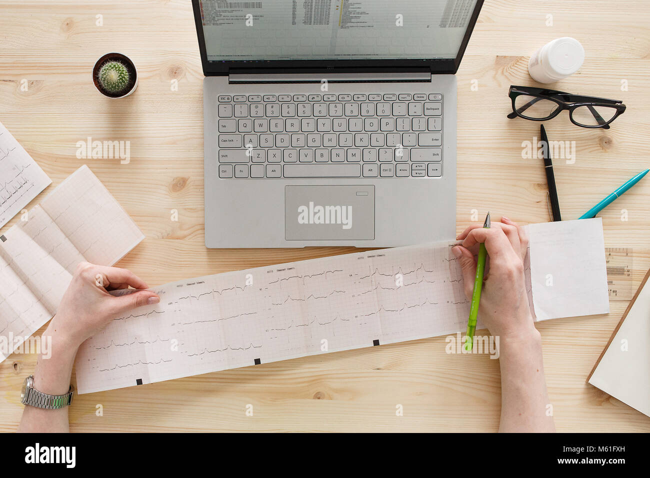 Professional doctor cardiologist analyzing a cardiogram of patients and ...