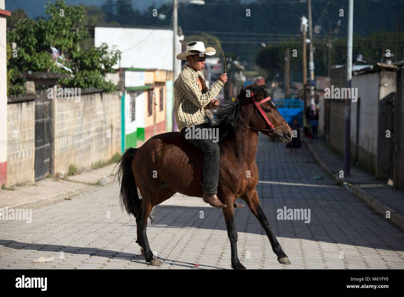 An indigenous Poqomchi' Maya cowboy rides through San Cristóbal Verapaz ...