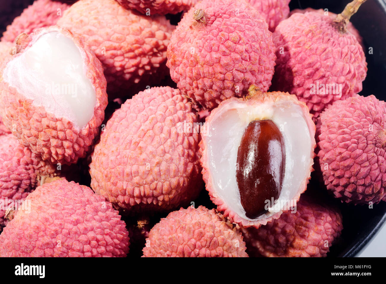 lychee fruits in a bowl isolated on white background Stock Photo - Alamy