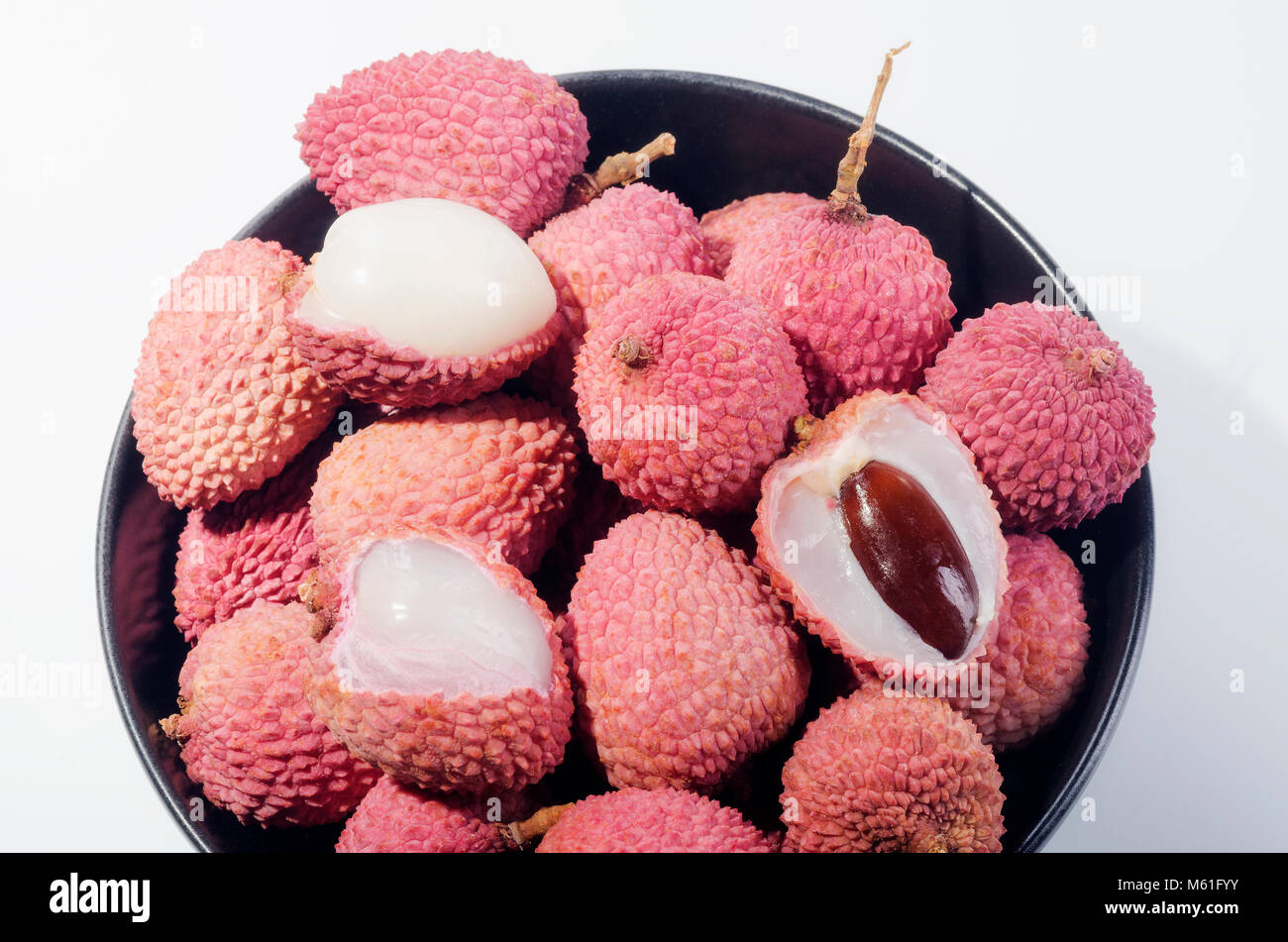 lychee fruits in a bowl isolated on white background Stock Photo - Alamy