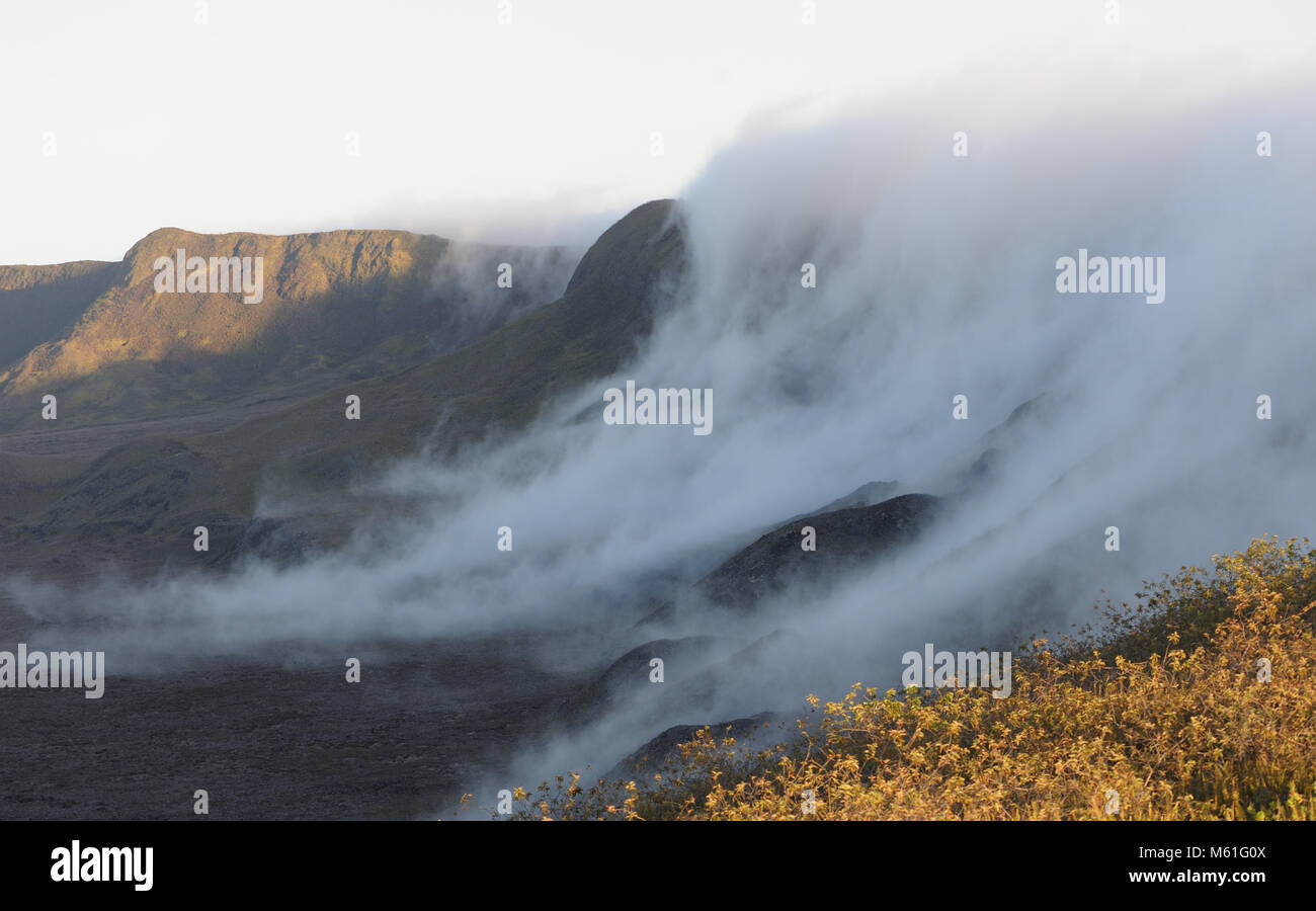 Cloud pours over the rim of Sierra Negra Volcano. Isabela, Galapagos ...
