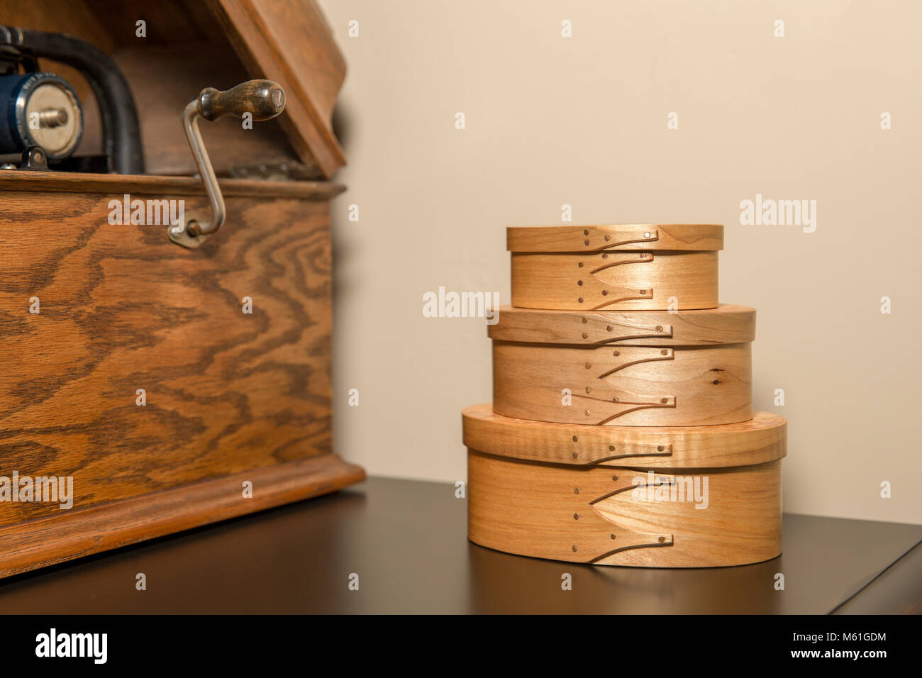 Vintage hand-crafted shaker boxes next to antique cylindrical ...