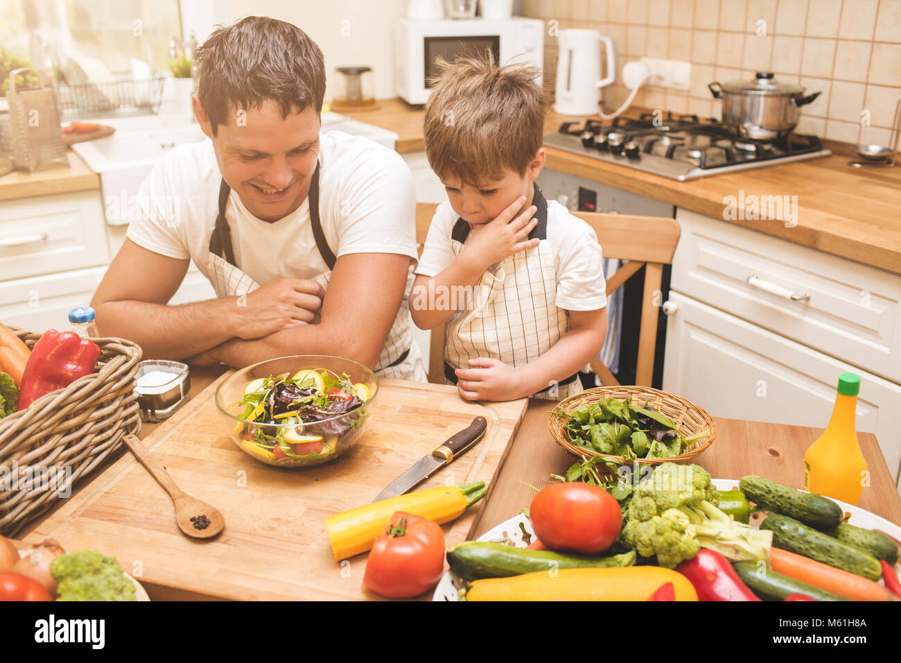 Father is cooking with his son Stock Photo - Alamy