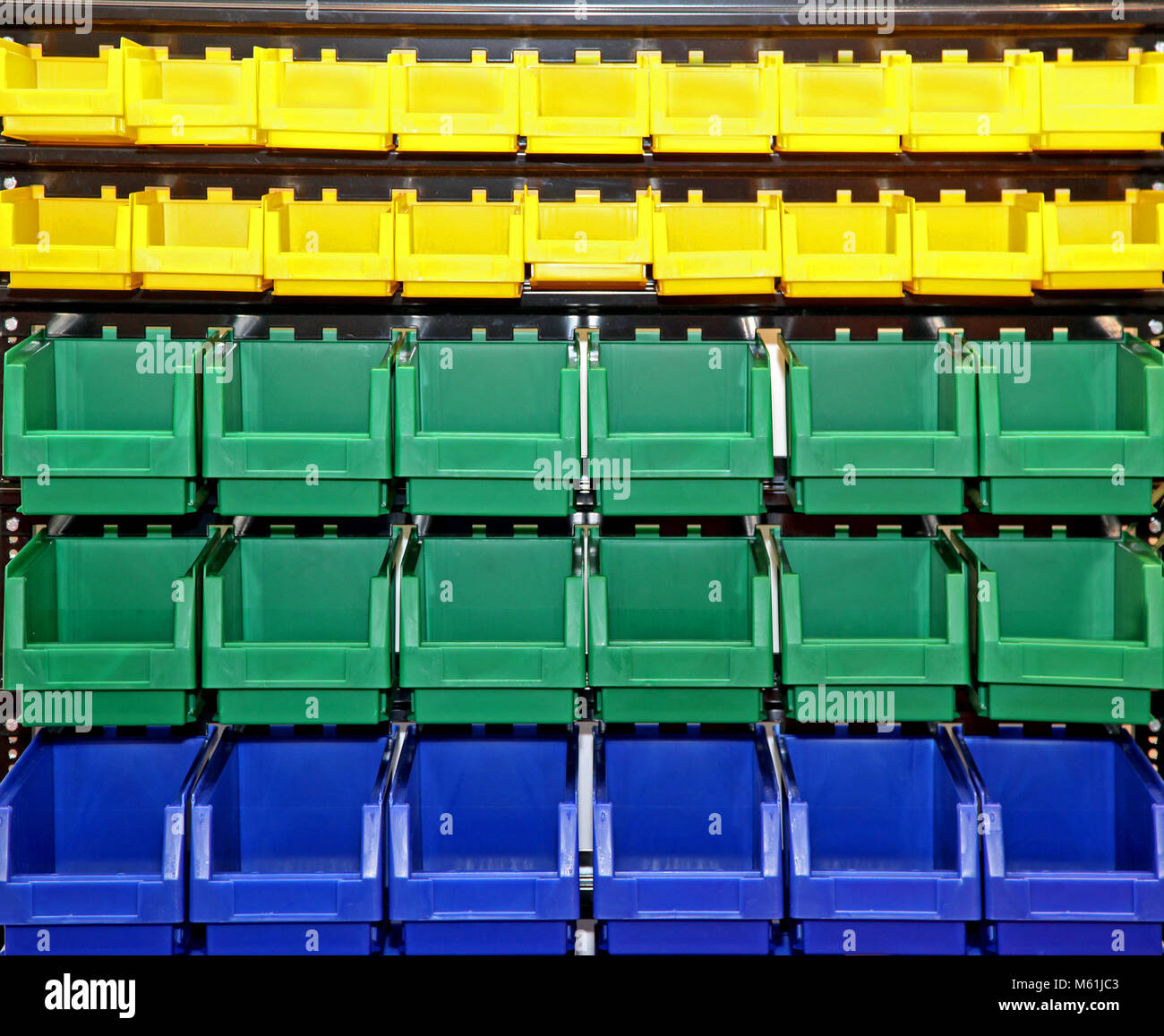Large shelf with empty plastic tool compartments Stock Photo - Alamy