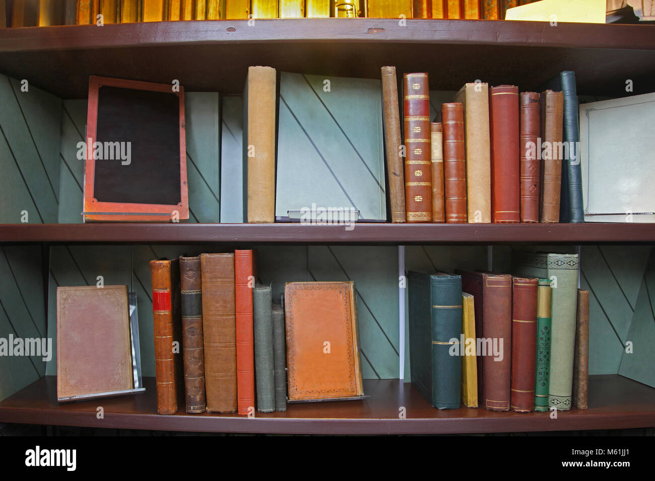 Old grunge books in leather binding on library shelf Stock Photo - Alamy