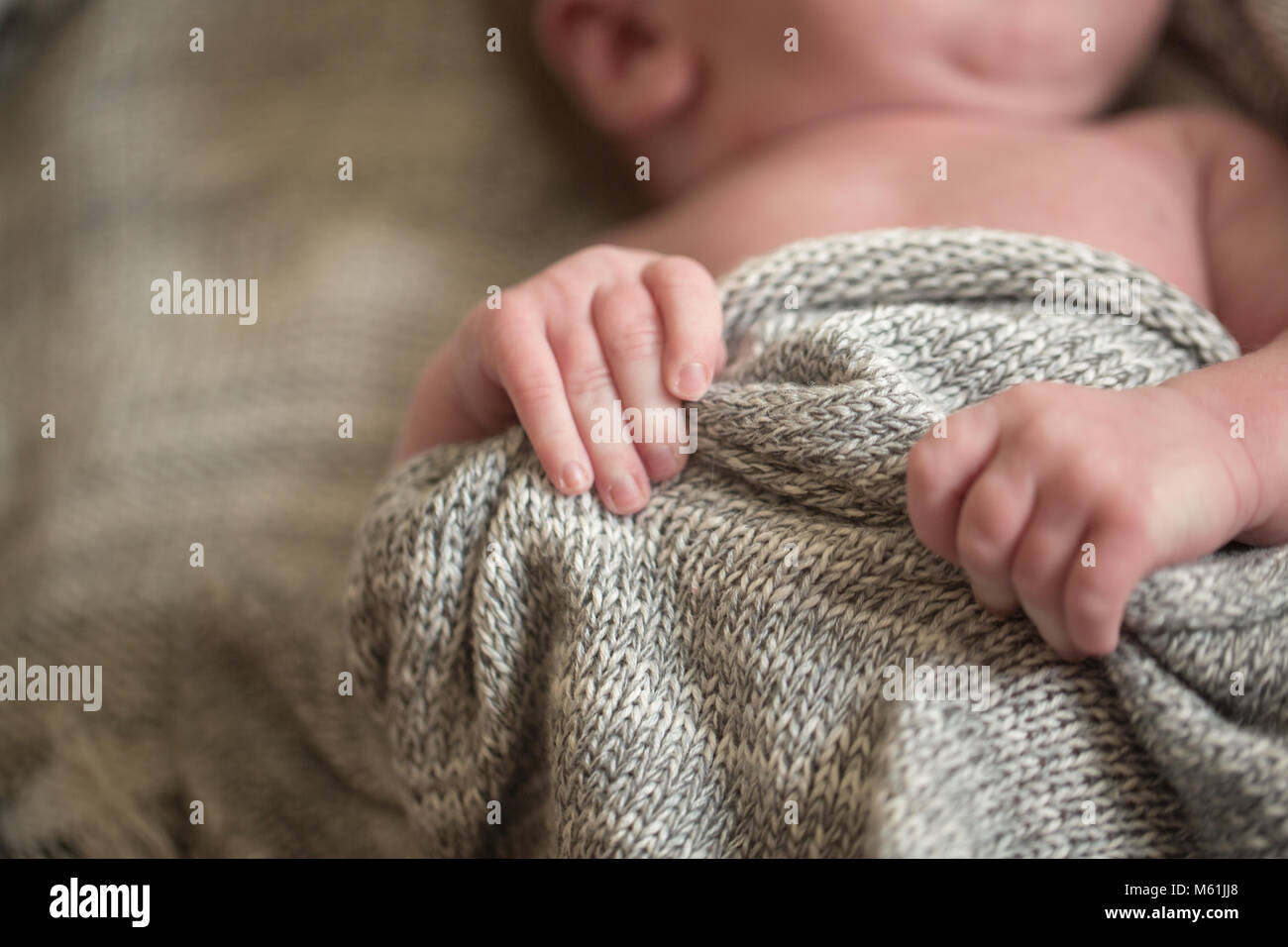 The child's hands hold a knitted blanket Stock Photo - Alamy