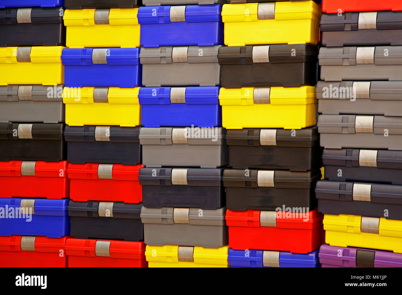 Large pile of colorful plastic closed tool boxes Stock Photo - Alamy