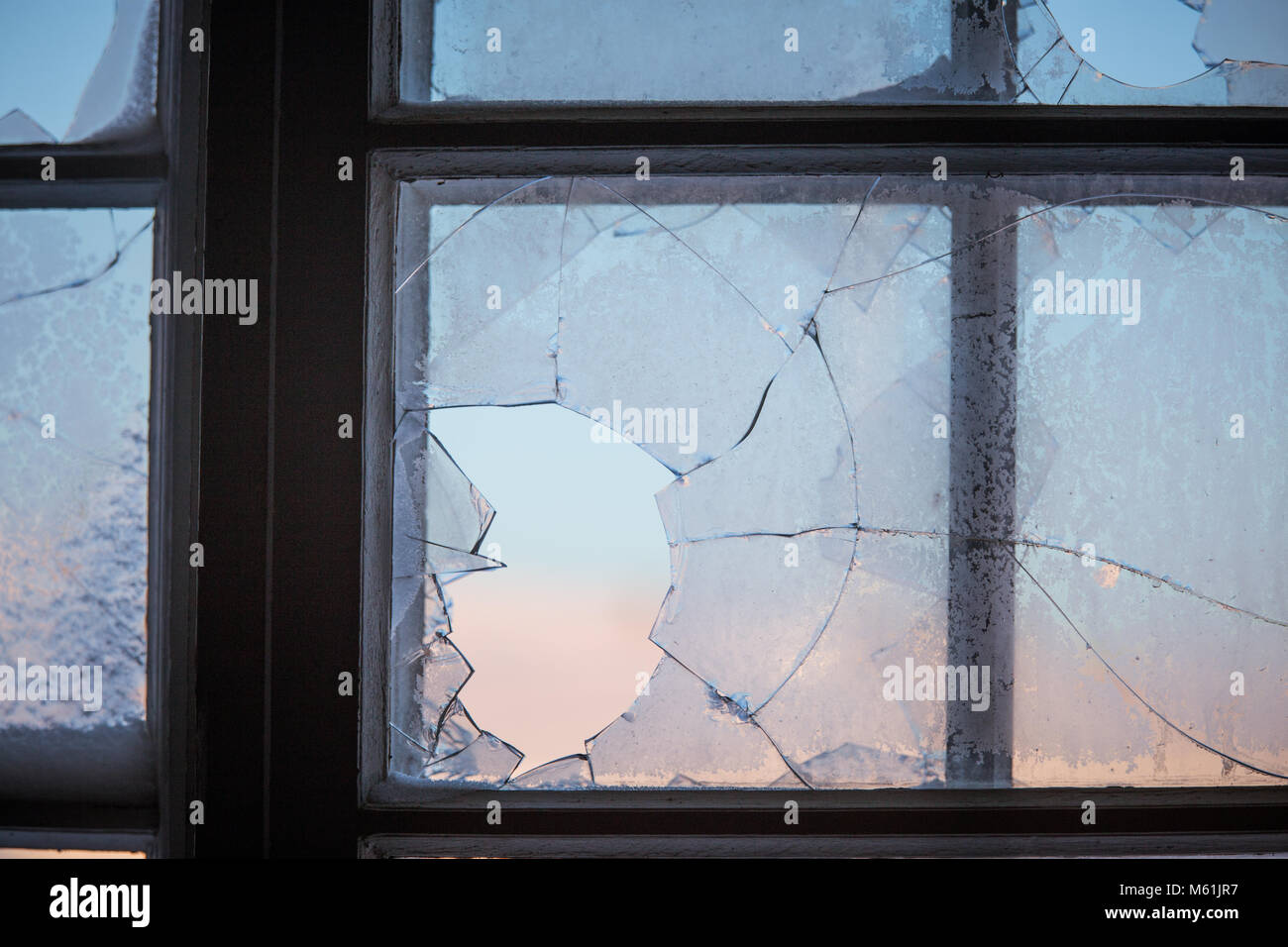 Broken window glass with a winter scenery outside. Ruined historic ...