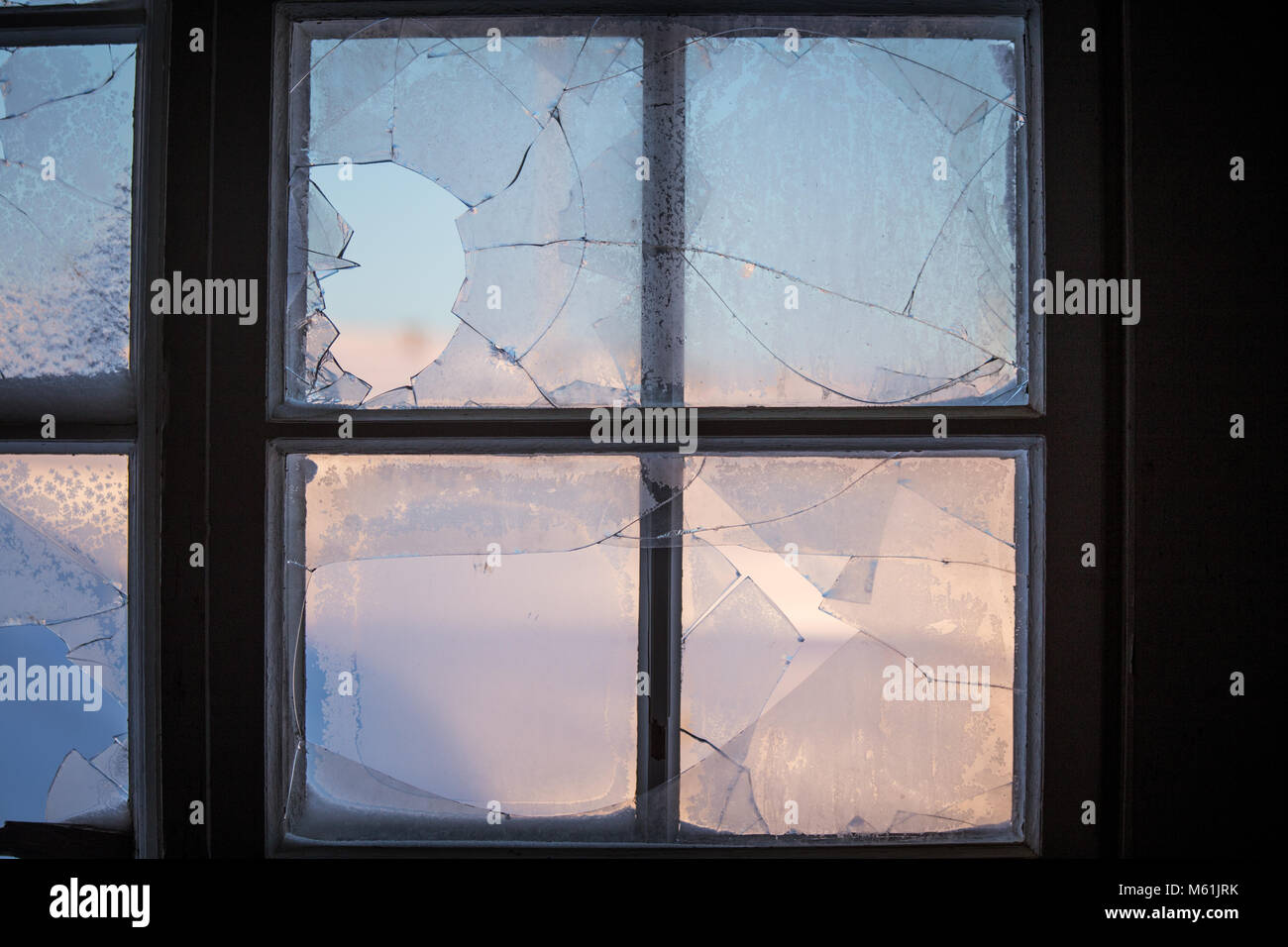 Broken window glass with a winter scenery outside. Ruined historic ...