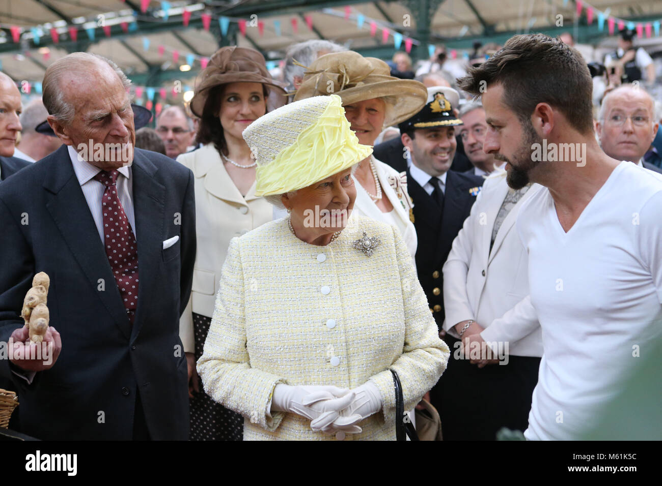 Britain's Queen Elizabeth II smiles while listening to Organic Veg ...