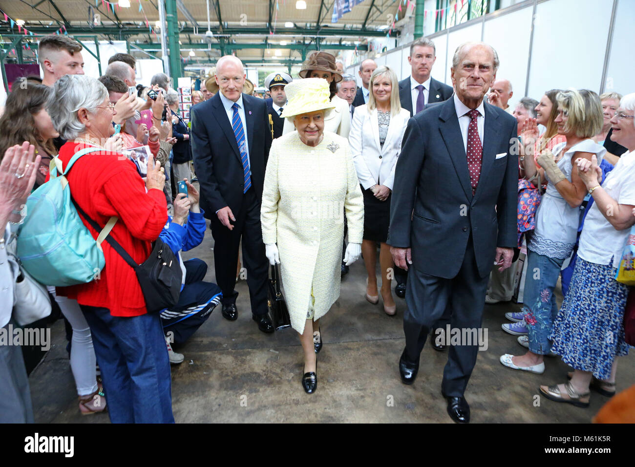 Local people clap as Britain's Queen Elizabeth II and the Duke of ...