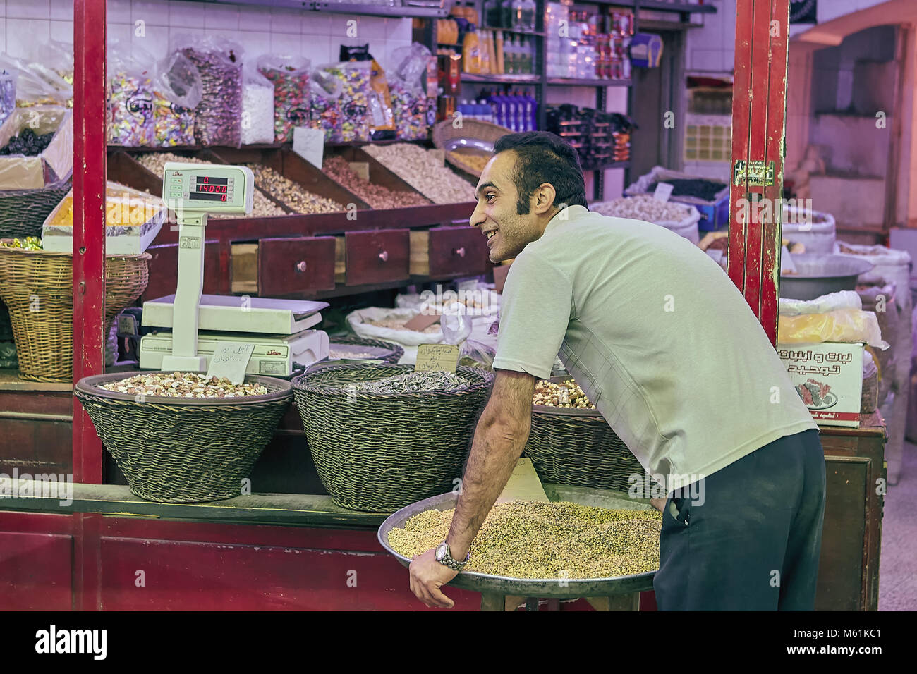 Kashan, Iran - April 25, 2017: Iranian grocer stands and smiles at a ...