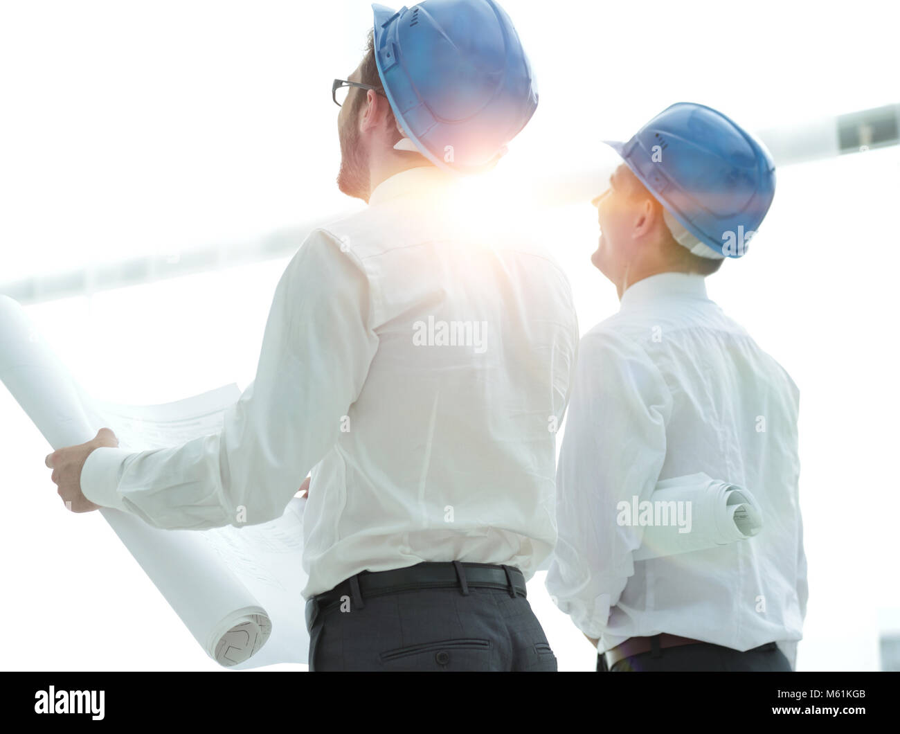 rear view.architect and Builder looking at blank screen Stock Photo - Alamy