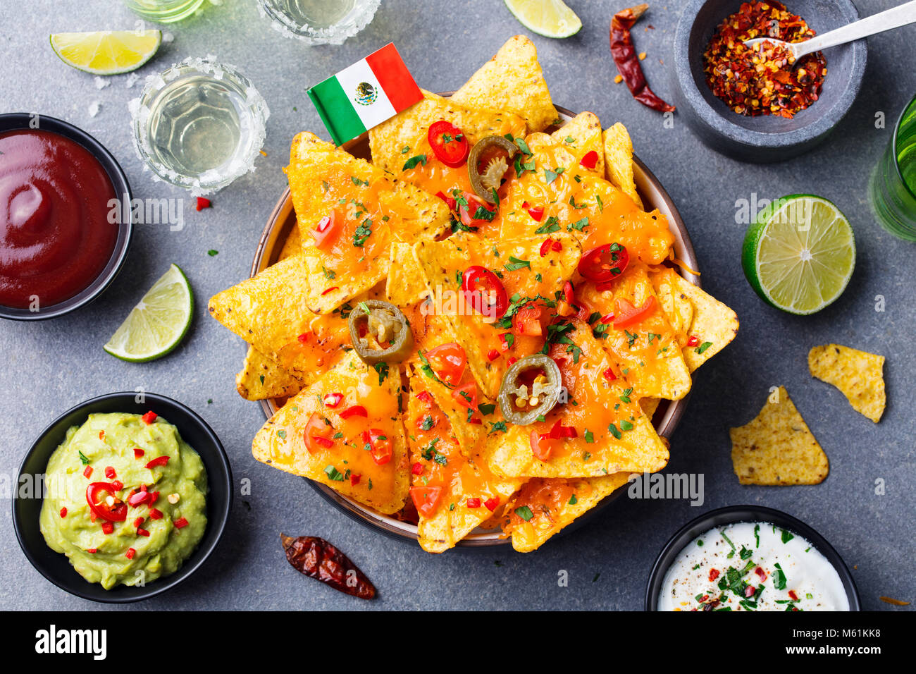 Nachos chips with Mexican flag and dips variety Stock Photo - Alamy