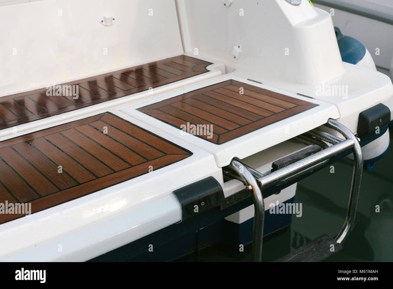 Back deck of motor boat and metal ladder on sunny day Stock Photo - Alamy