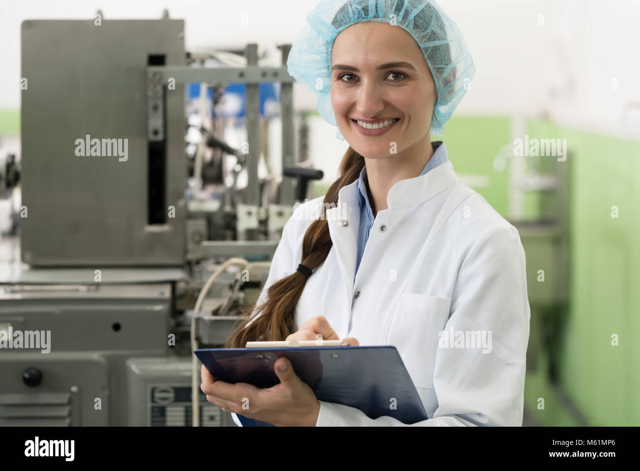 Portrait of woman quality inspector during work in cosmetics factory ...