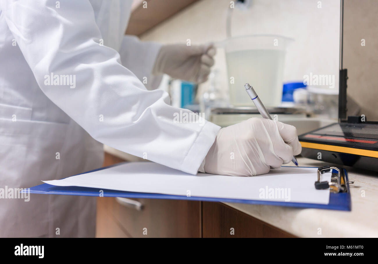 Close-up of the hands of an expert analyzing sample in the laboratory ...