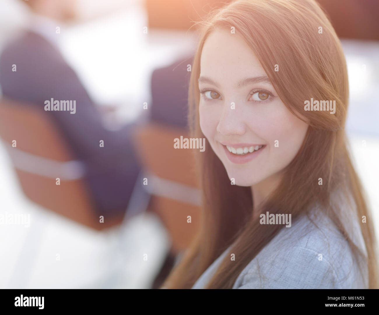smiling female assistant in the background of the office.photo with ...