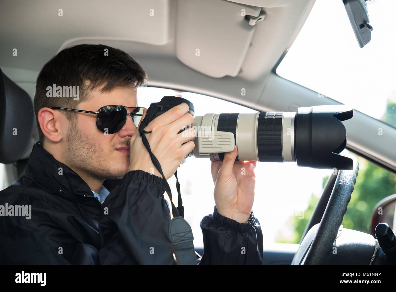 Side View Of A Private Detective Sitting Inside Car Photographing With ...