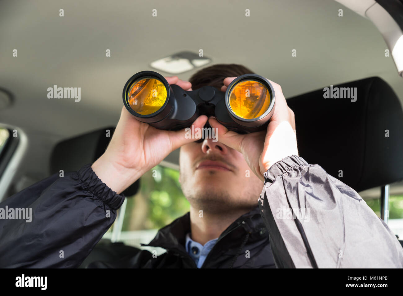 Close-up Of A Man Sitting Inside Car Looking Through Binocular Stock ...