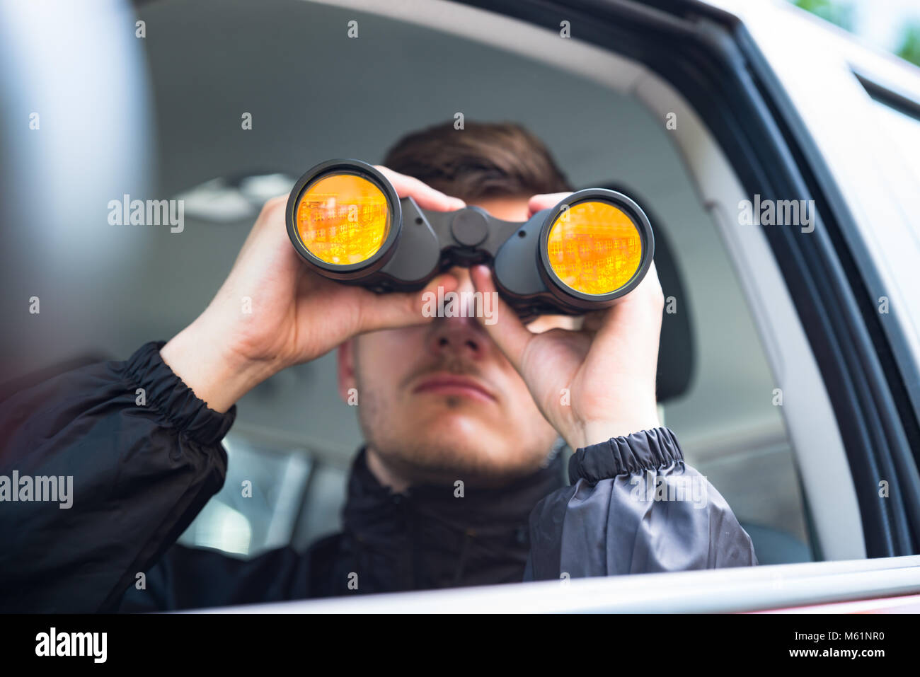 Close-up Of A Man Sitting Inside Car Looking Through Binocular Stock ...
