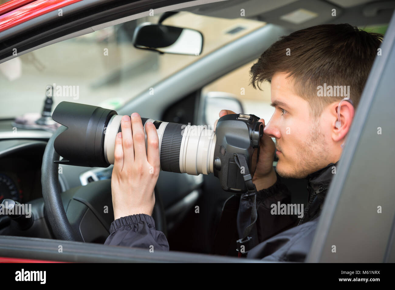 Close-up Of A Young Man Inside Car Photographing With Slr Camera Stock ...