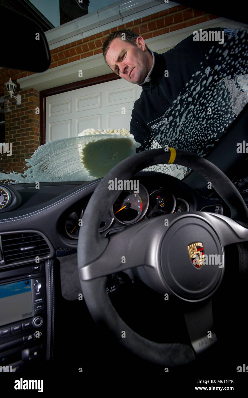 Car valeter washing a Porsche sports car Stock Photo - Alamy
