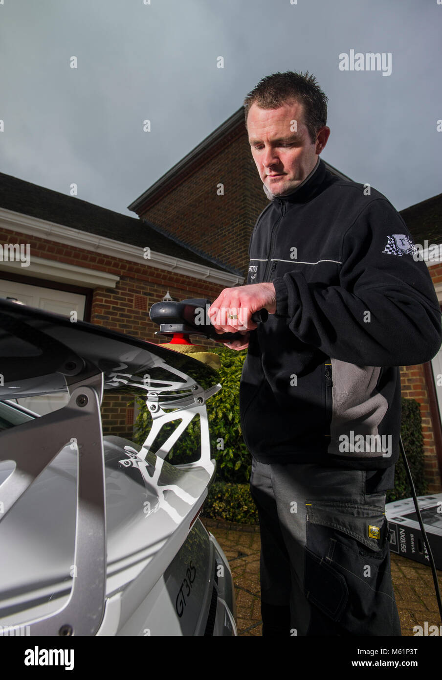 Car valeter detailing a Porsche sports car Stock Photo - Alamy