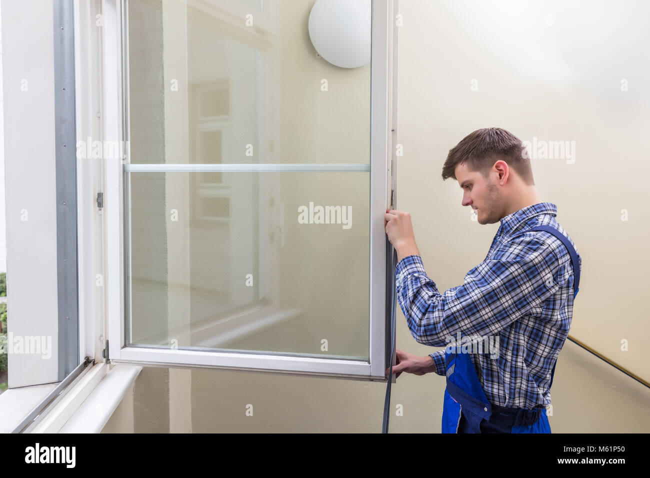 Close-up Of A Repairman's Hand Fixing Window Stock Photo - Alamy