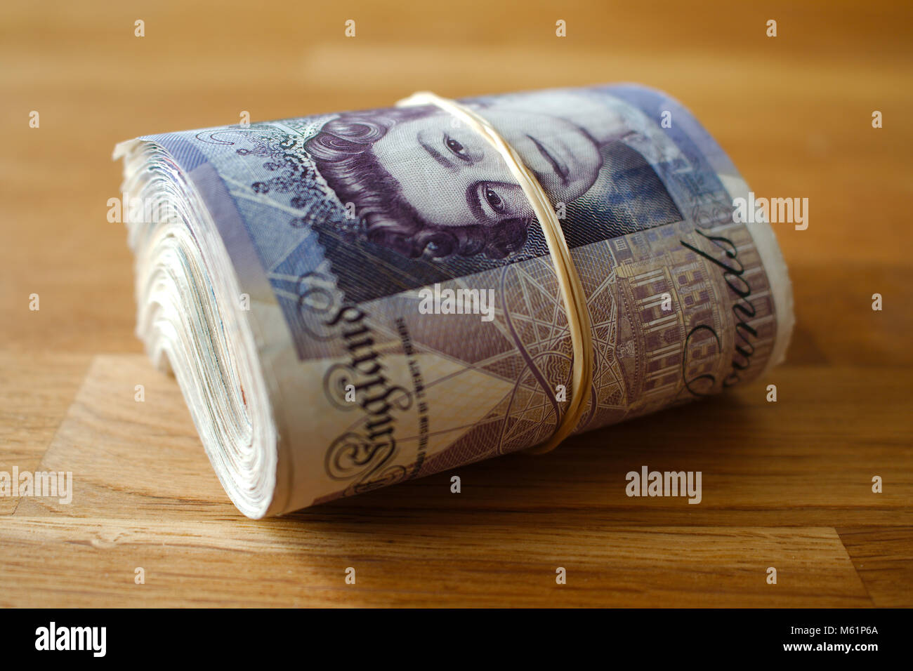 A rolled up bunch of bank notes, giving the impression of wealth Stock ...