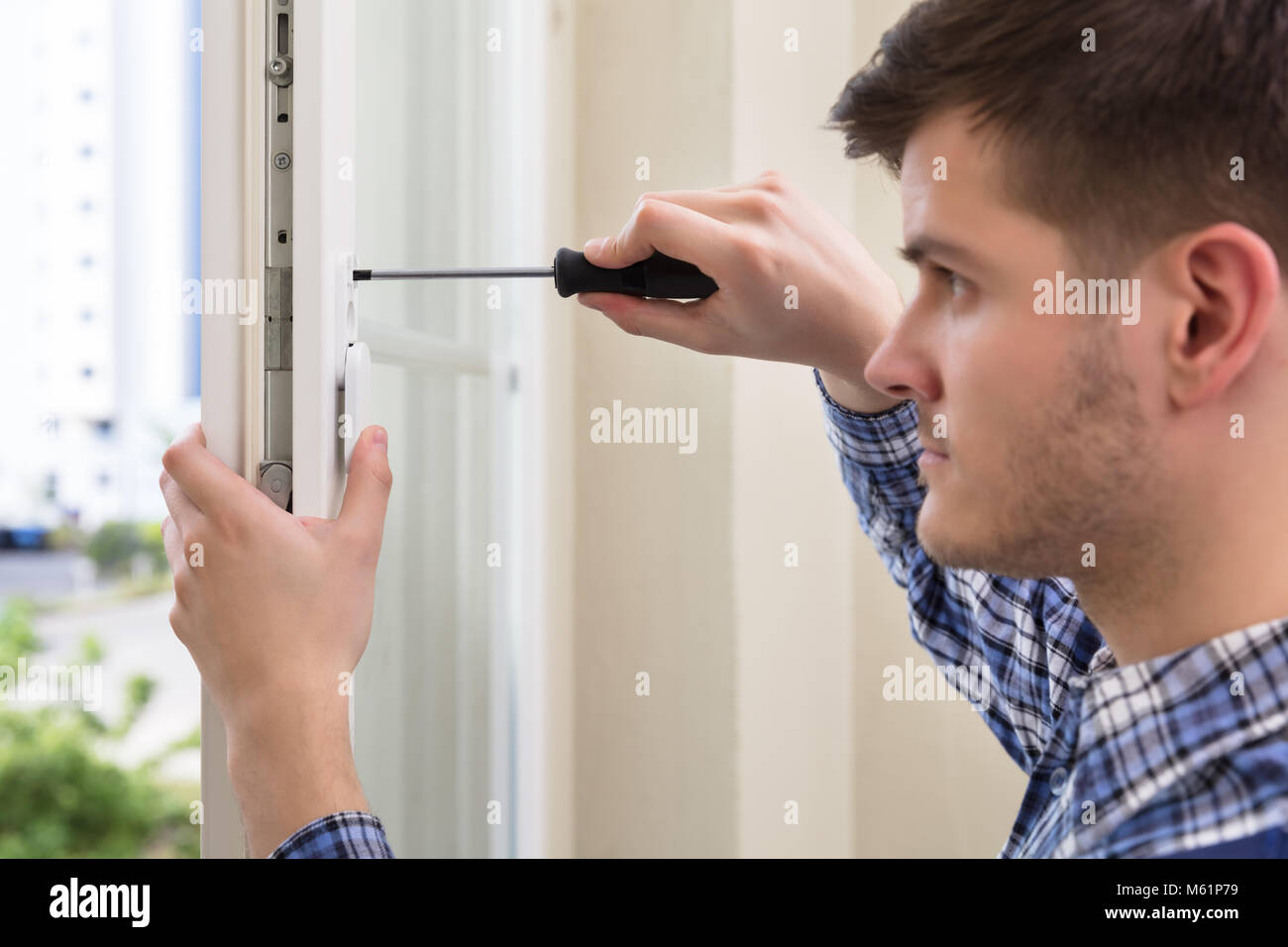 Close-up Of A Male Repairman Fixing Window With Screwdriver Stock Photo ...