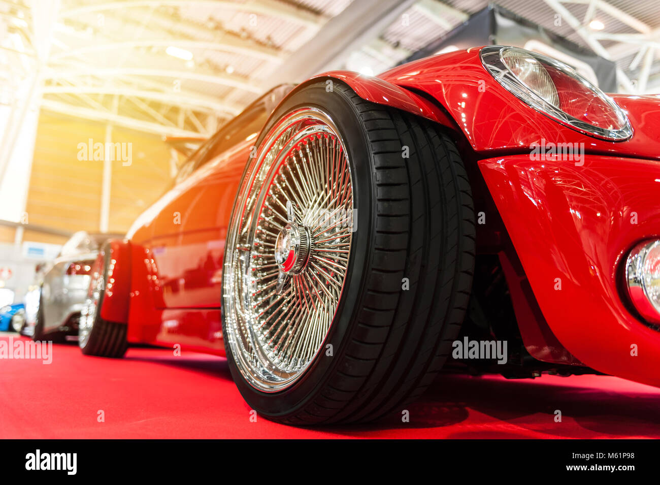 Red custom car in a showroom with sunlight Stock Photo - Alamy