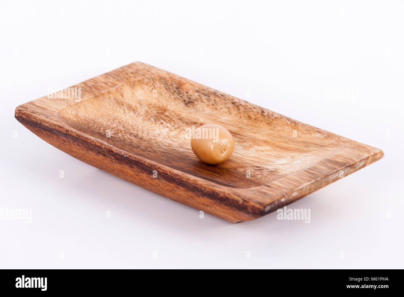 Single green olive on a wooden tray Stock Photo - Alamy